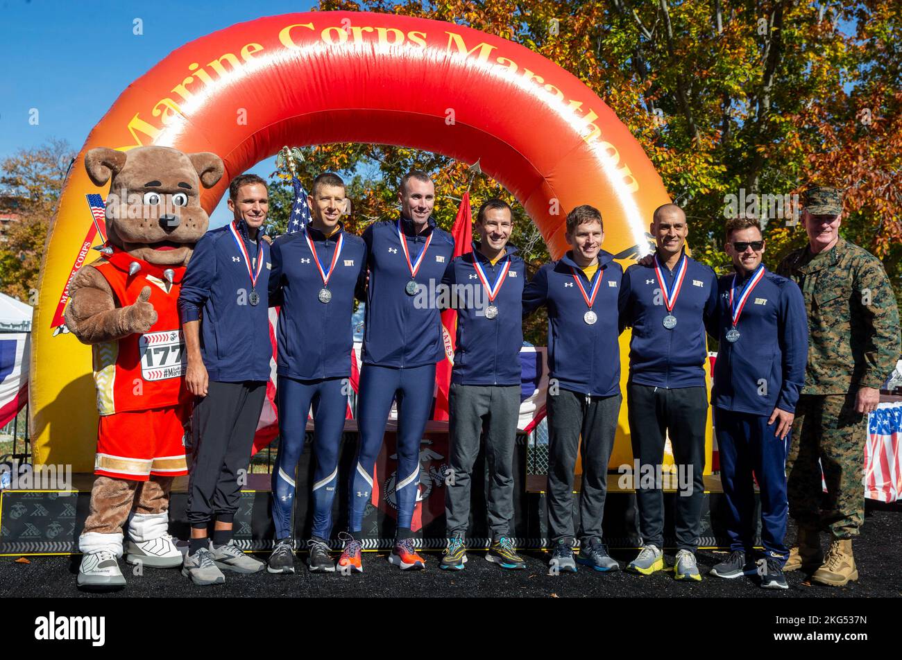 Members of the U.S. Navy Running Team pose together with their medals ...