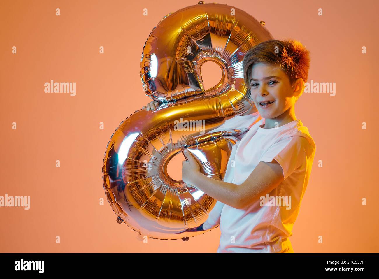 A boy with the number eight in his hands. Eight-year-old boy Stock ...