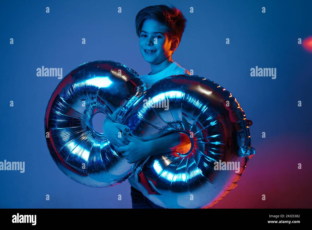 A boy with the number eight in his hands. Eight-year-old boy Stock ...