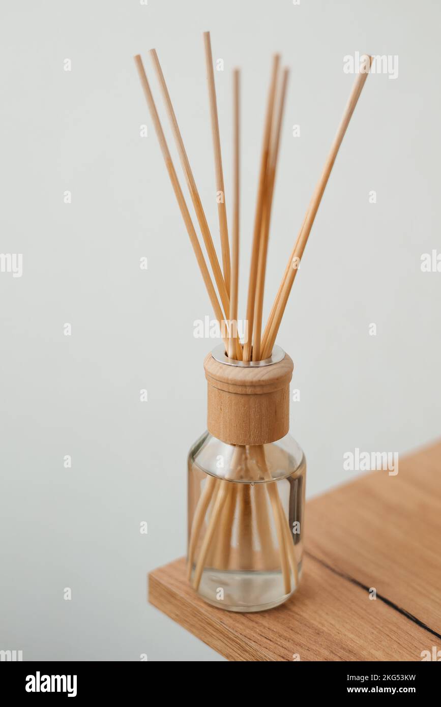 Reed air freshener on table in room Stock Photo - Alamy