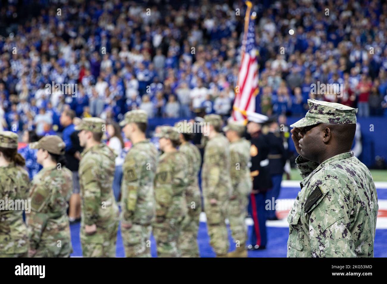 Petty Officer 1st Class Terrance Williams salutes the flag, alongside ...
