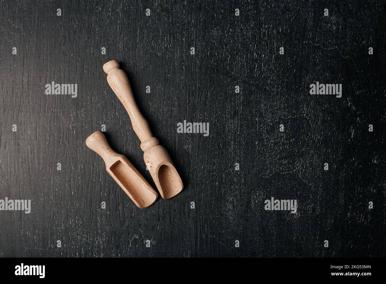 Two wooden loaches on a black background. Wooden kitchen accessories ...