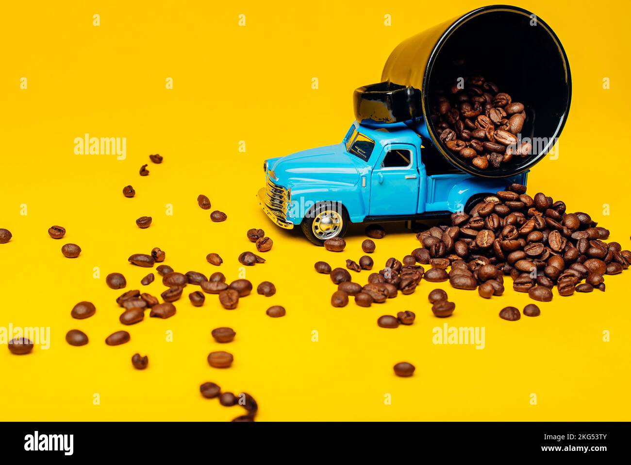 Coffee beans and a toy car on a yellow background Stock Photo - Alamy