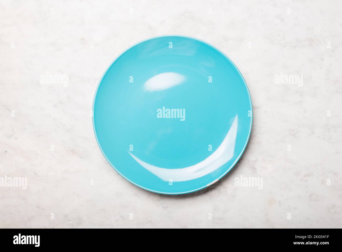 Empty blue plate on a light marble background Stock Photo - Alamy
