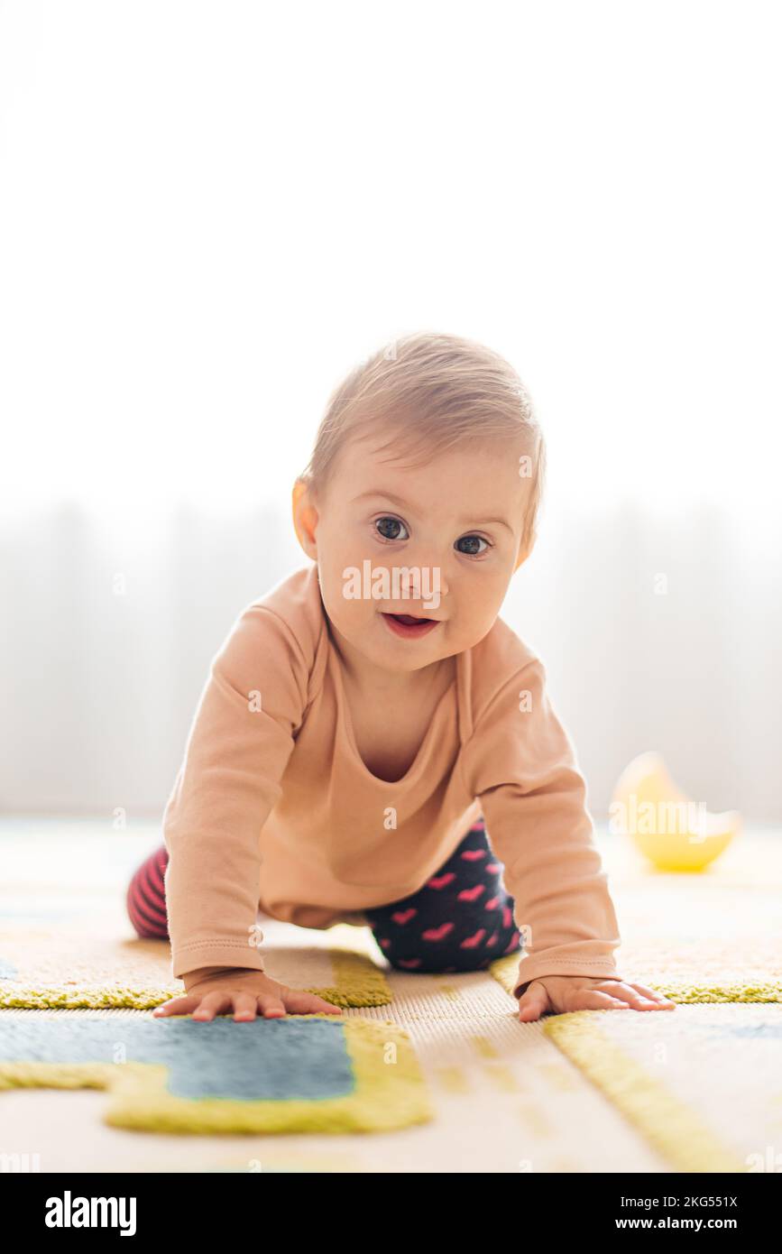 child learns to crawl on the floor Stock Photo - Alamy