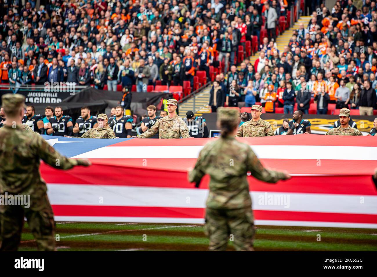 Airmen from the 501st Combat Support Wing unveil an American flag ...