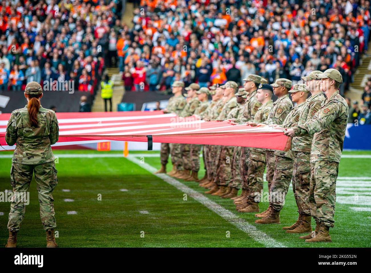 Airmen from the 501st Combat Support Wing hold an American flag during ...