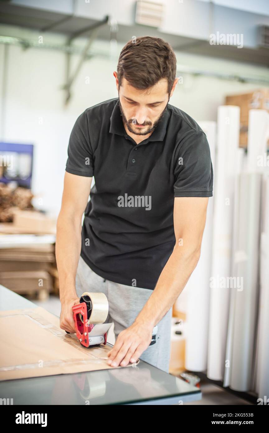 Professional worker printmaker technician operator works in printing ...