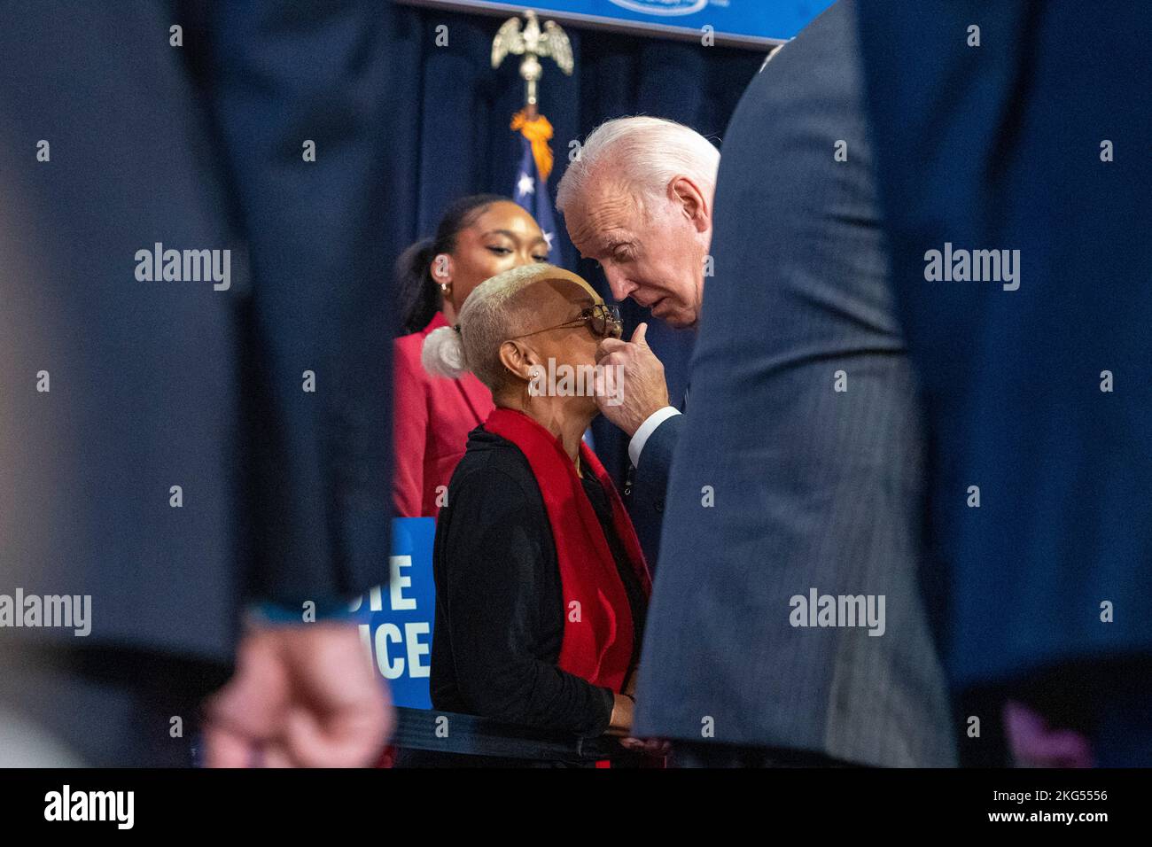 United States President Joe Biden speaks to a special guest on stage ...