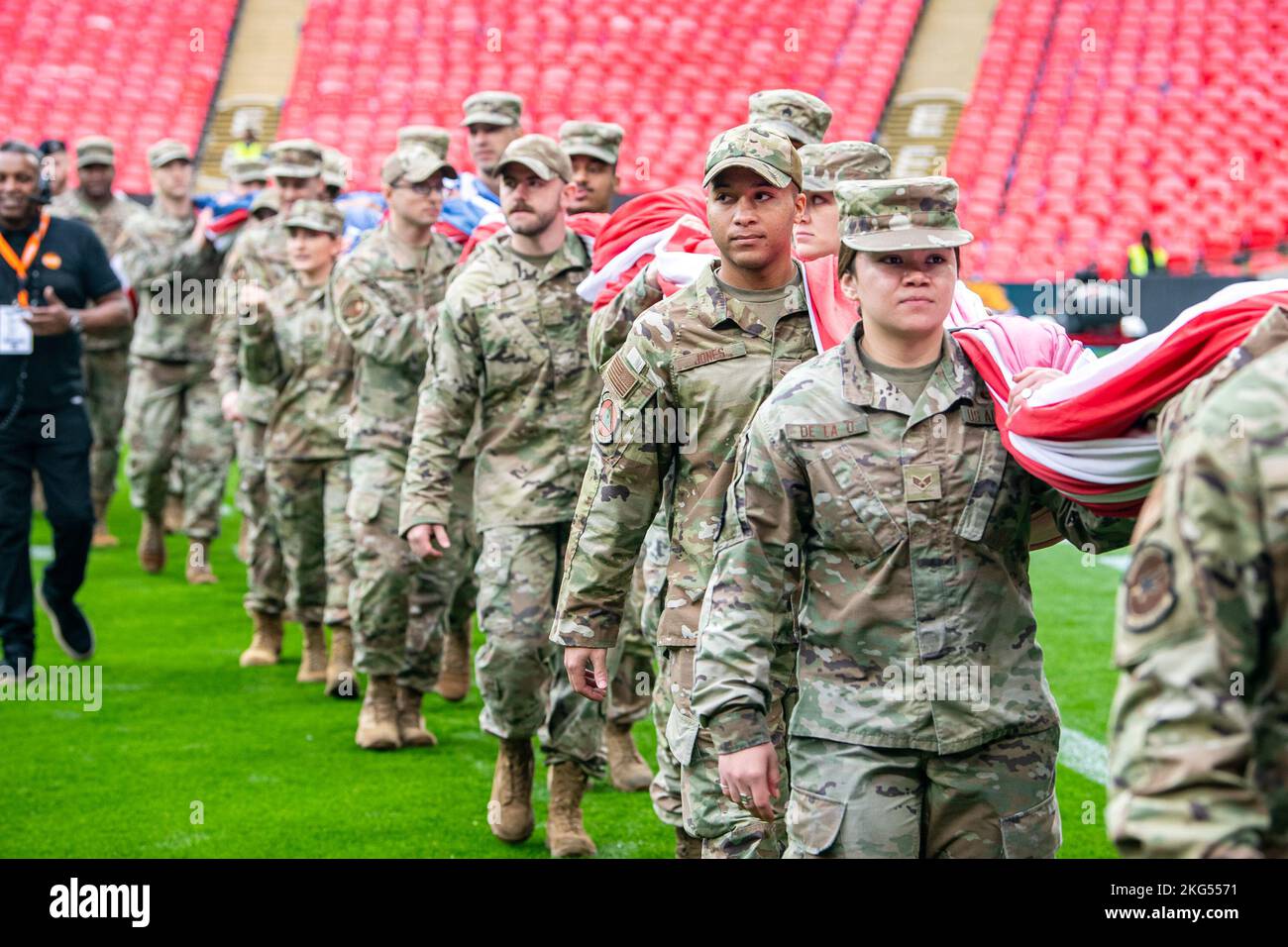 Airmen from the 501st Combat Support Wing carry an American flag ...