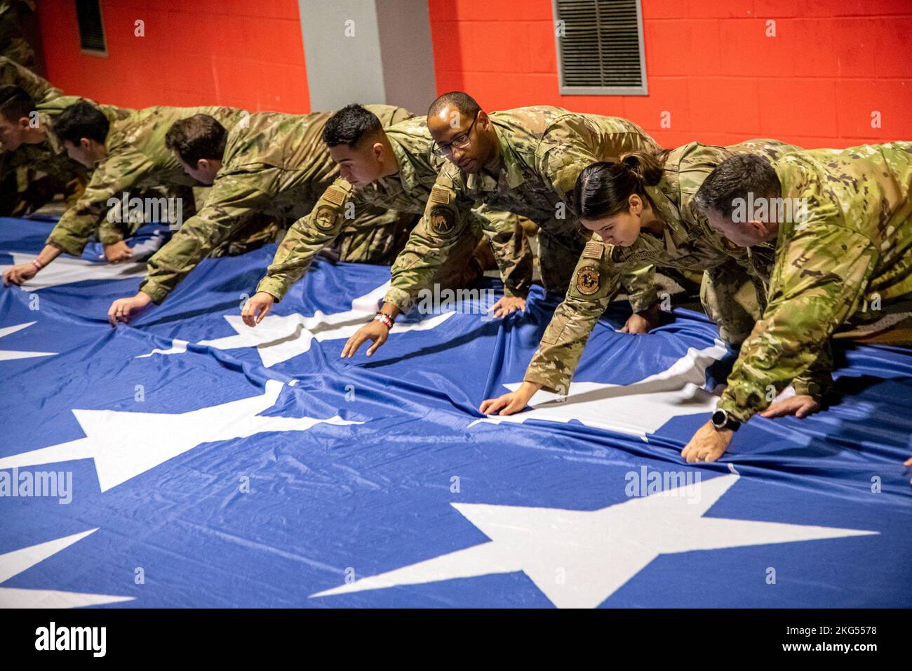 Airmen from the 501st Combat Support Wing grab the seam of an American ...