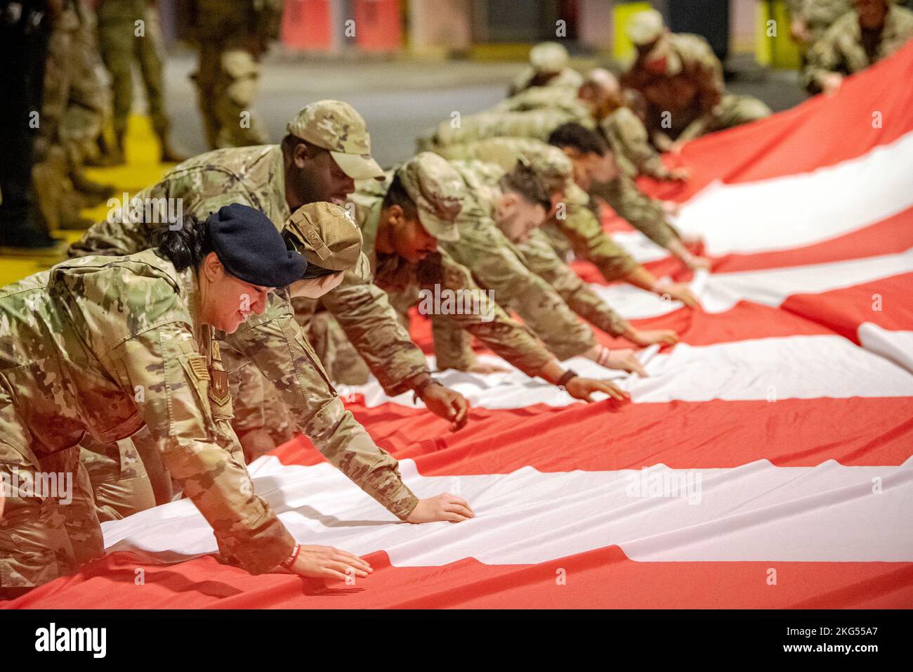 Airmen from the 501st Combat Support Wing grab the seam of an American ...