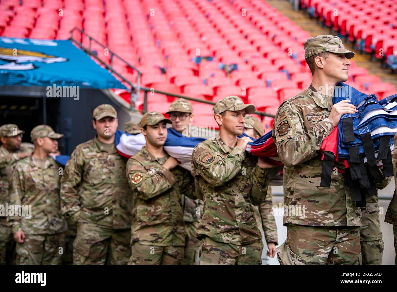 Airmen from the 501st Combat Support Wing hold an American flag prior ...