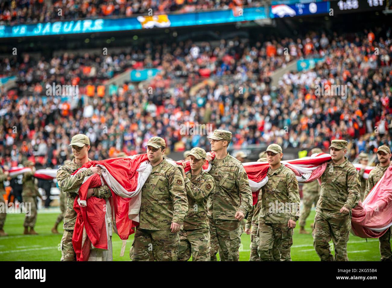 Airmen from the 501st Combat Support Wing carry an American flag off ...
