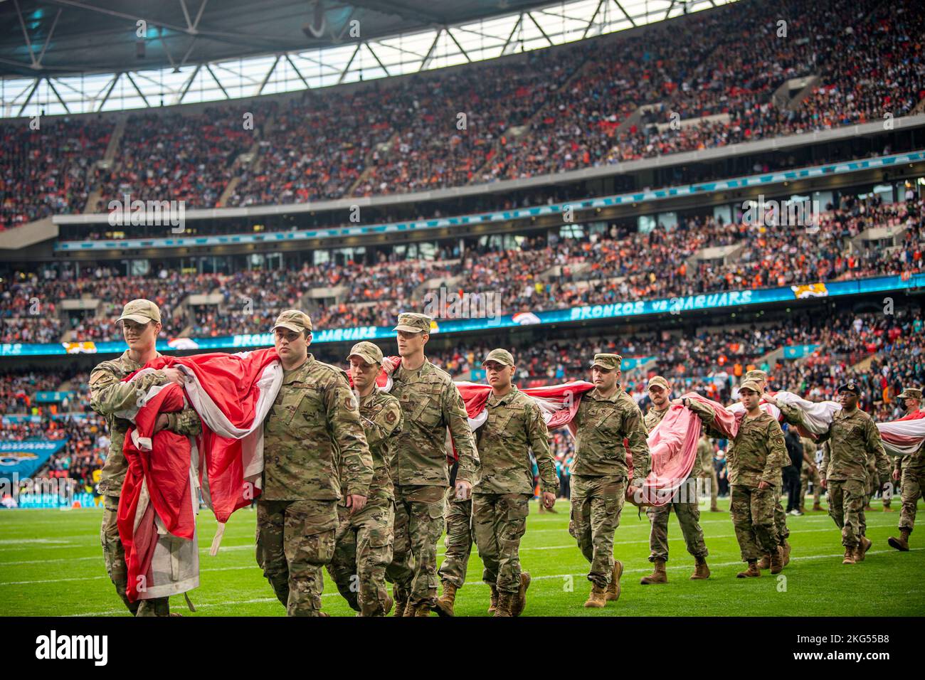 Airmen from the 501st Combat Support Wing carry an American flag off ...