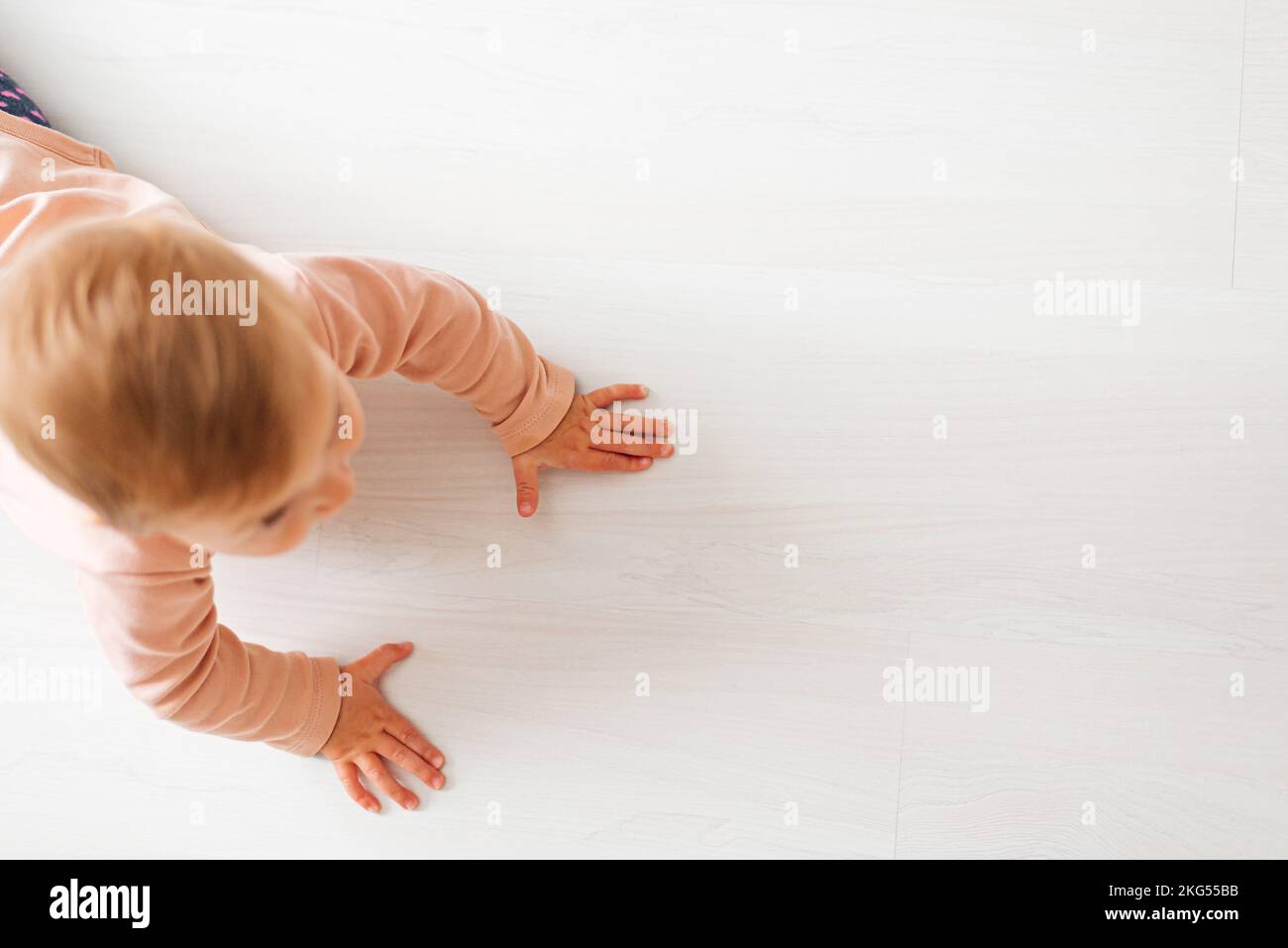 baby on wood floor learning to crawl on floor Stock Photo - Alamy