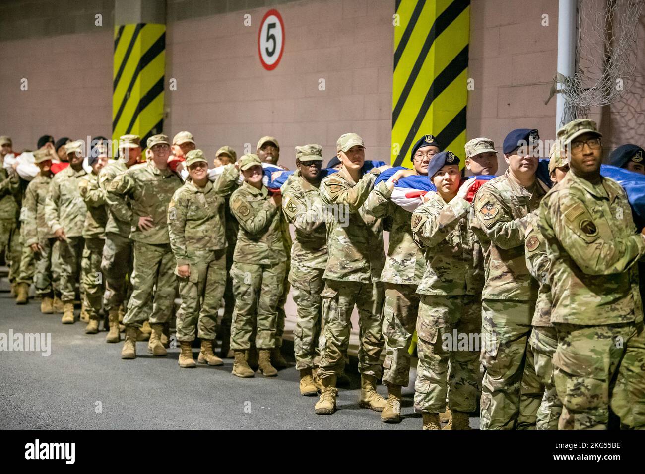 Airmen from the 501st Combat Support Wing hold an American Flag prior ...