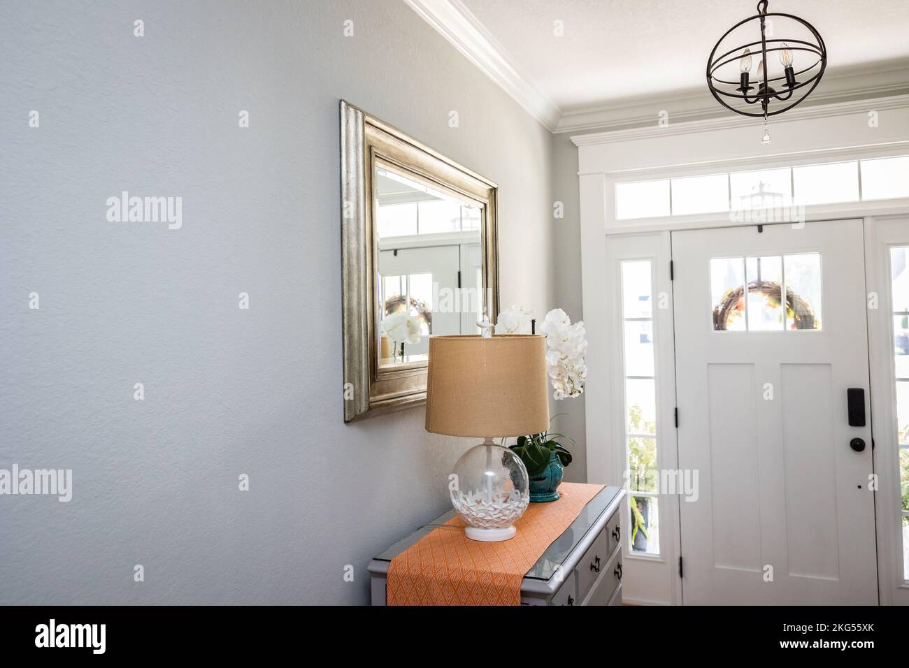 An open large and wide interior front door hallway foyer with transom ...