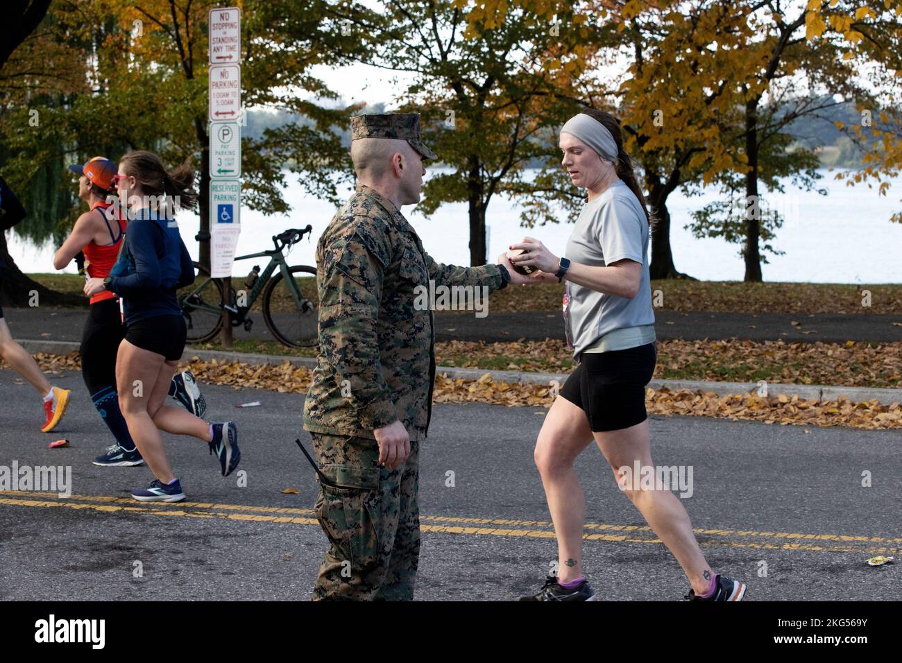 Volunteers hand out water to runners as they pass by, Washington, DC on ...