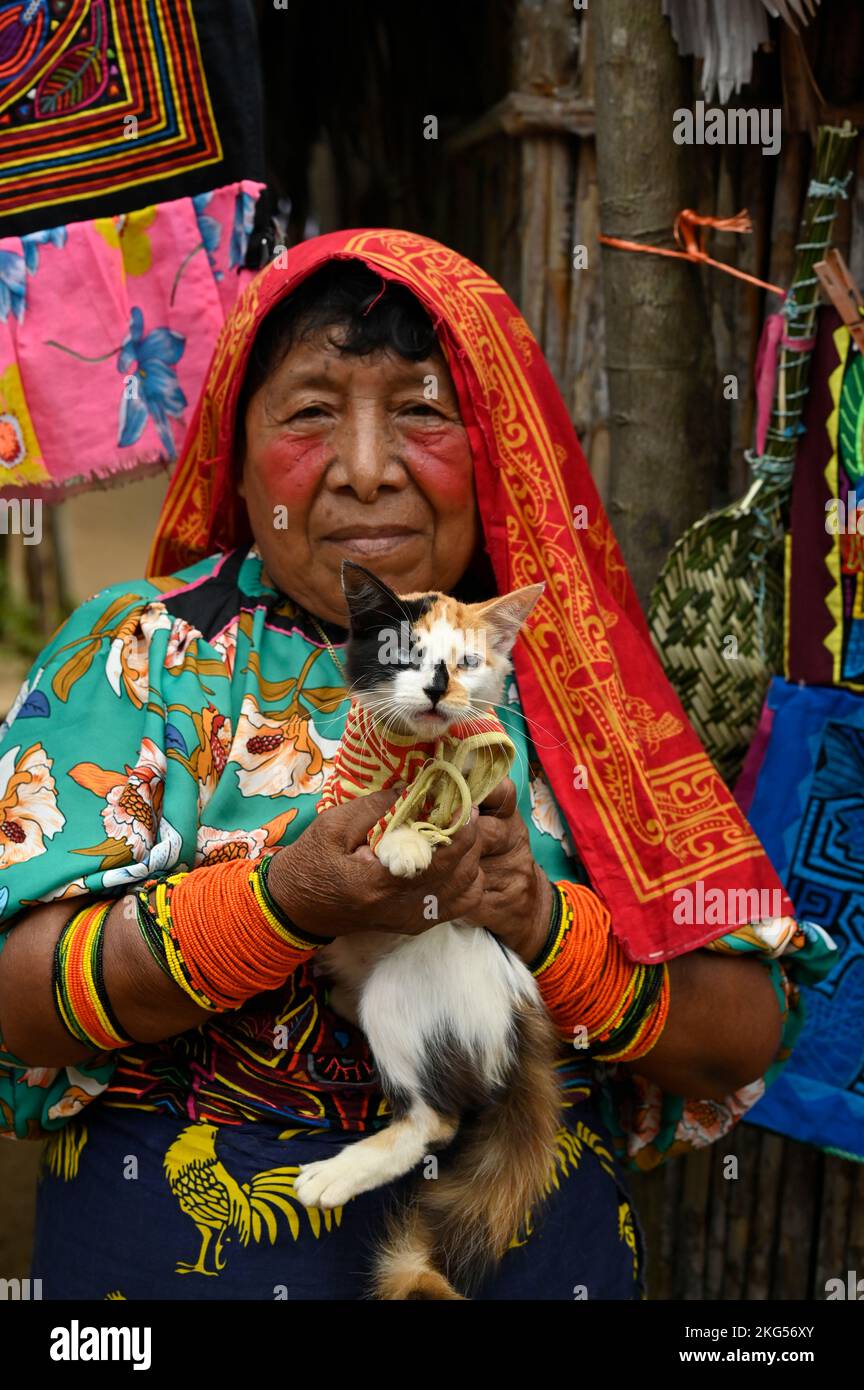 Portrait of an indigenous holding a cat, wearing the traditional molas ...