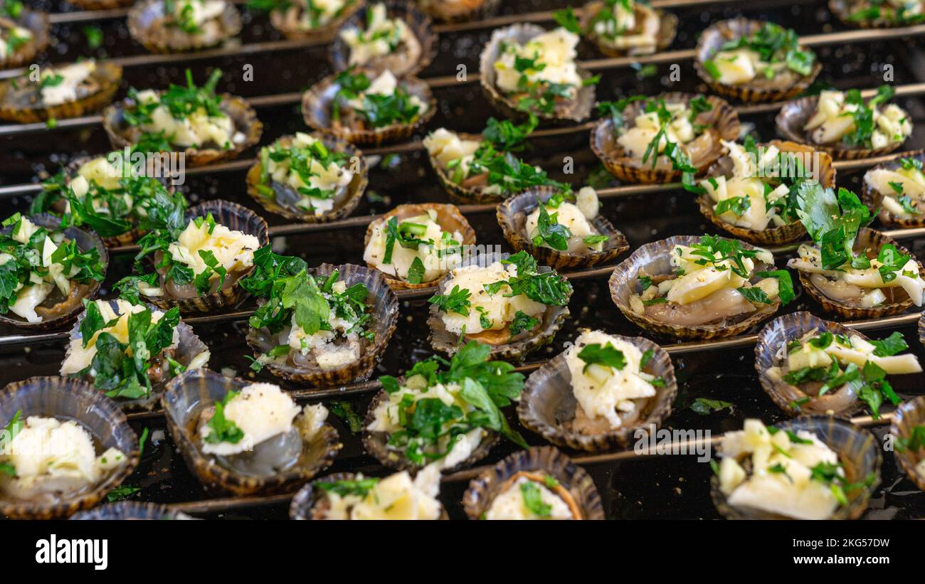 Limpets molluscs with garlic parsley butter Stock Photo - Alamy