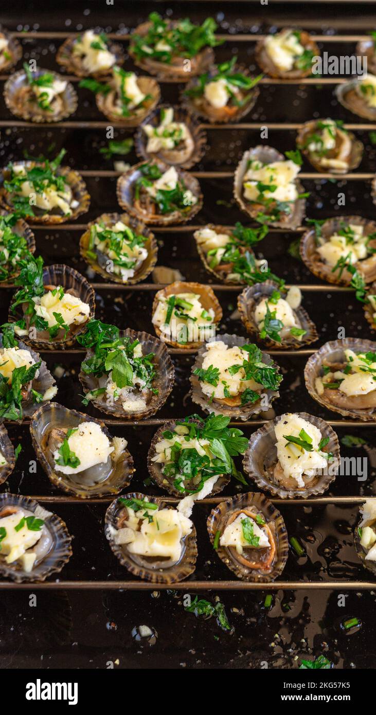 Limpets molluscs with garlic parsley butter Stock Photo - Alamy