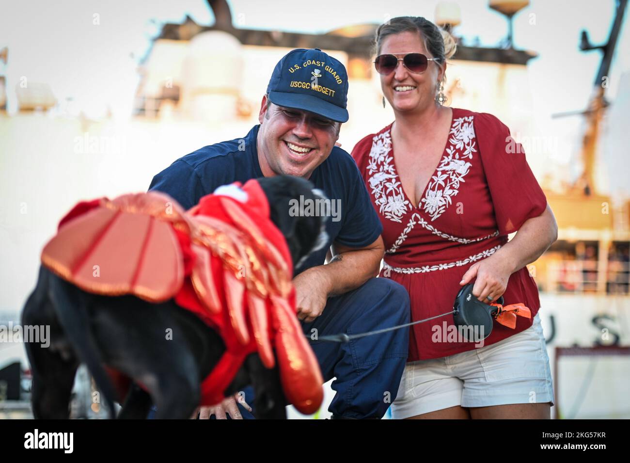 Petty Officer 2nd Class Wesley Pollard and his wife play with their dog ...