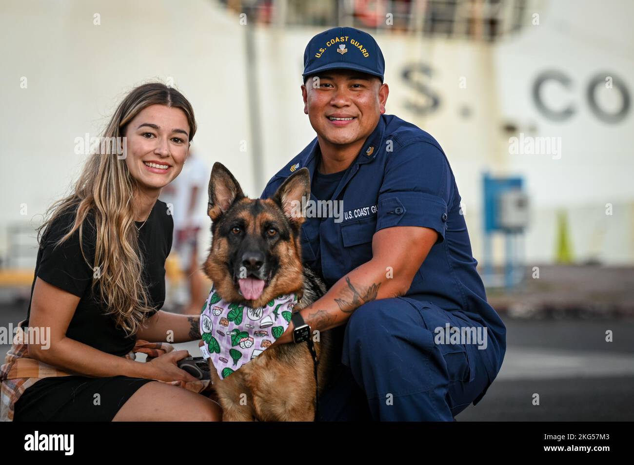Petty Officer 1st Class Tyler Fuller poses with his wife and their dog ...