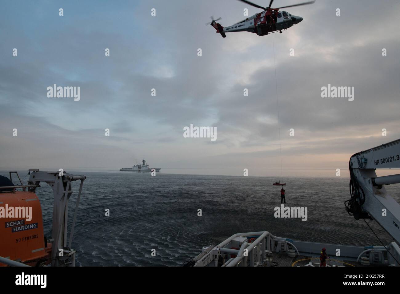 Crewmembers assigned to USCGC Hamilton (WMSL 753) are hoisted down onto ...