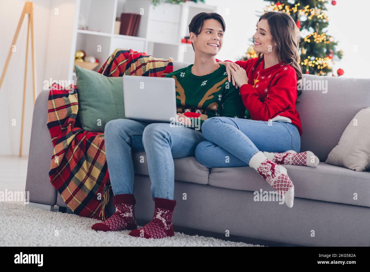 Photo of attractive sweet family husband wife wear ugly jumpers socks relax rest comfy couch ...
