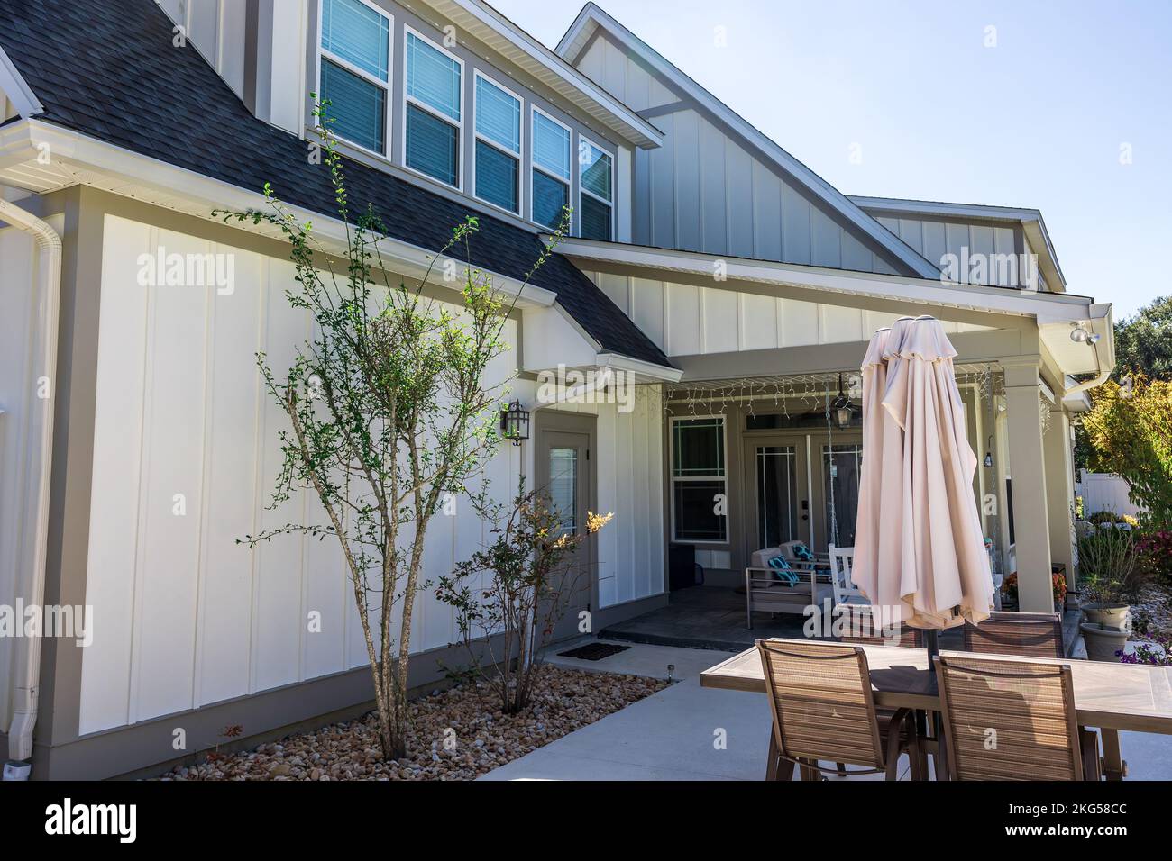 The side view of a long craftsman cottage white cream new construction ...