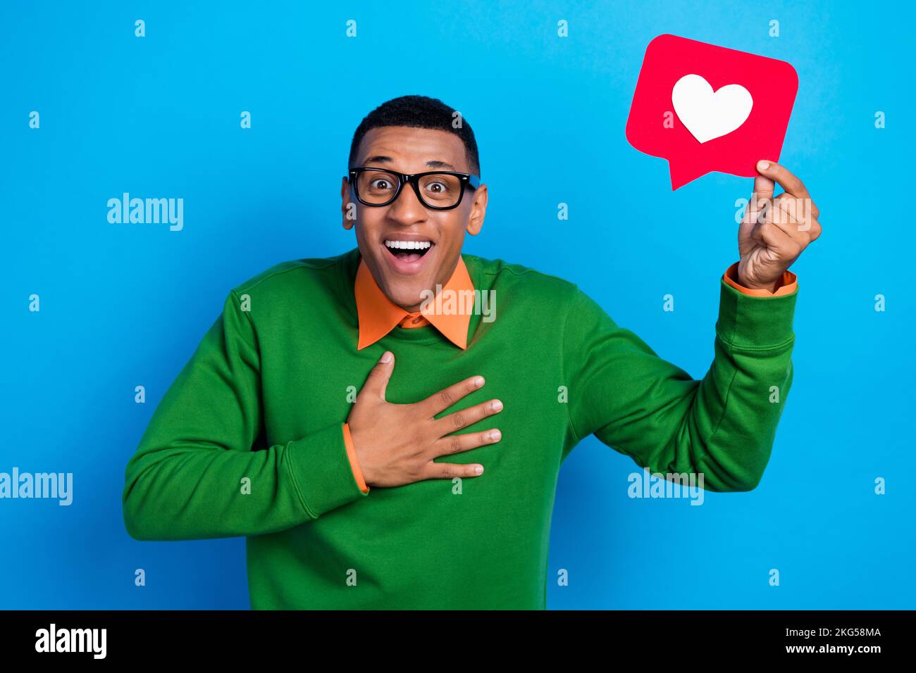 Photo of young popular student blogger guy wear green jumper hold red ...