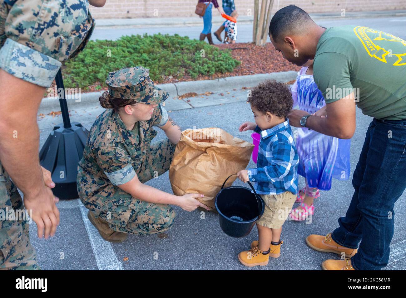 U.S Marine Corps Lance Cpl. Destiny Cheas distributes candy to a child ...