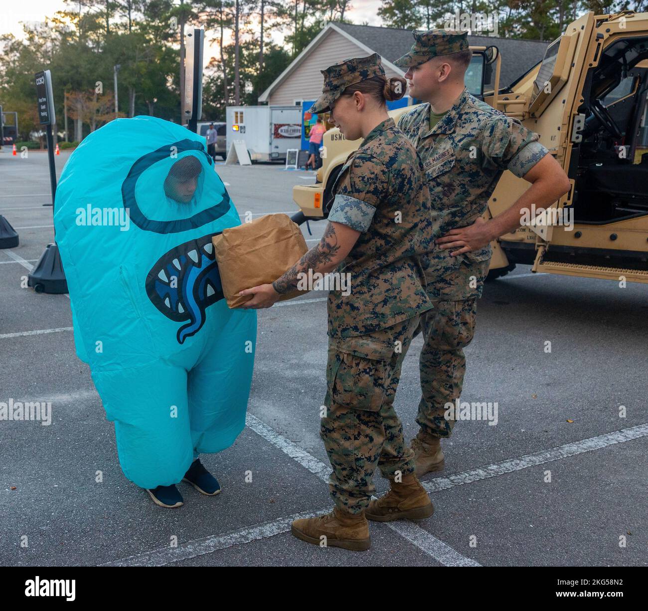 U.S Marine Corps Lance Cpl. Destiny Cheas distributes candy to a child ...