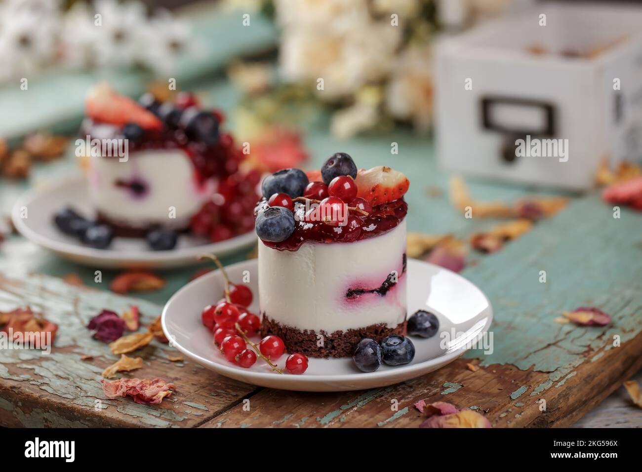 A closeup of Mini fruit cake on a blue wooden background, surrounded ...