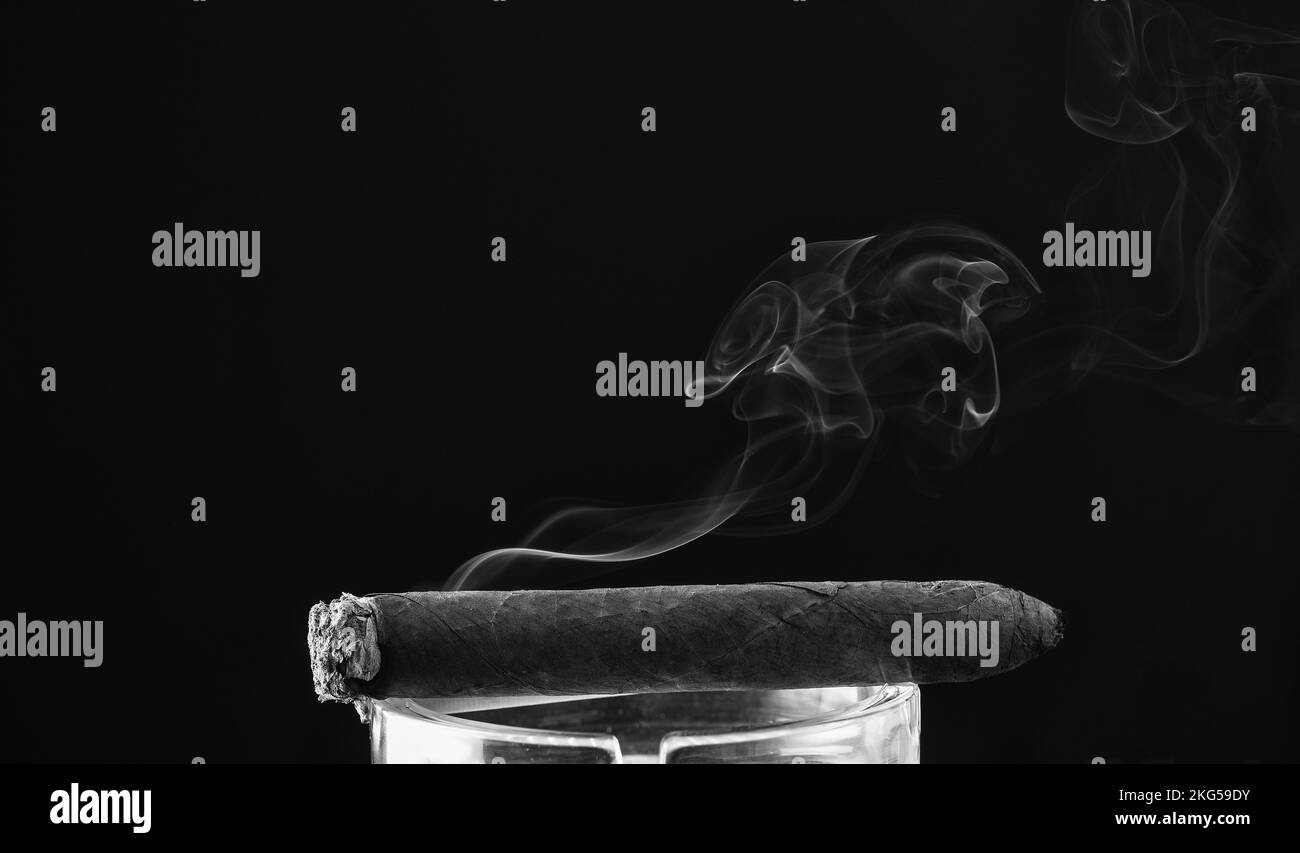 Steaming cuban cigar with smoke puff dark background, copy space ...