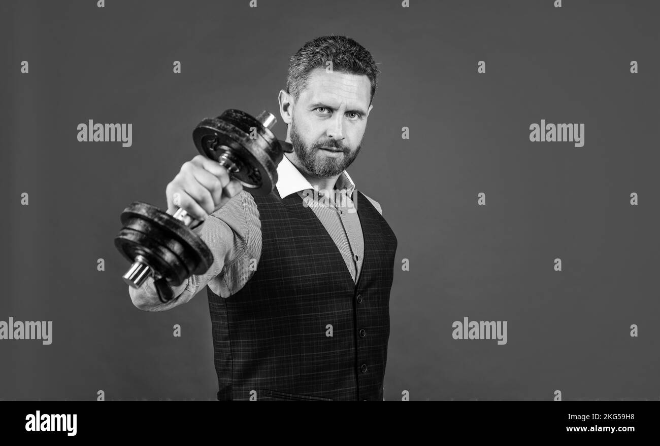 Strong man manager do dumbbell workout red background, business Stock ...