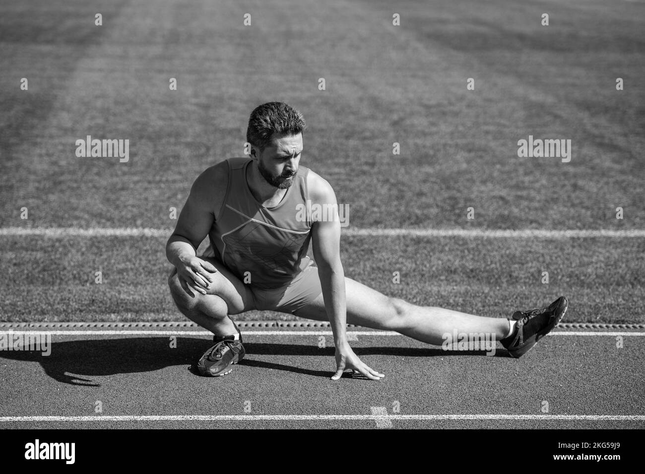 Athletic Muscular Man Stretching Muscules Before Workout Training