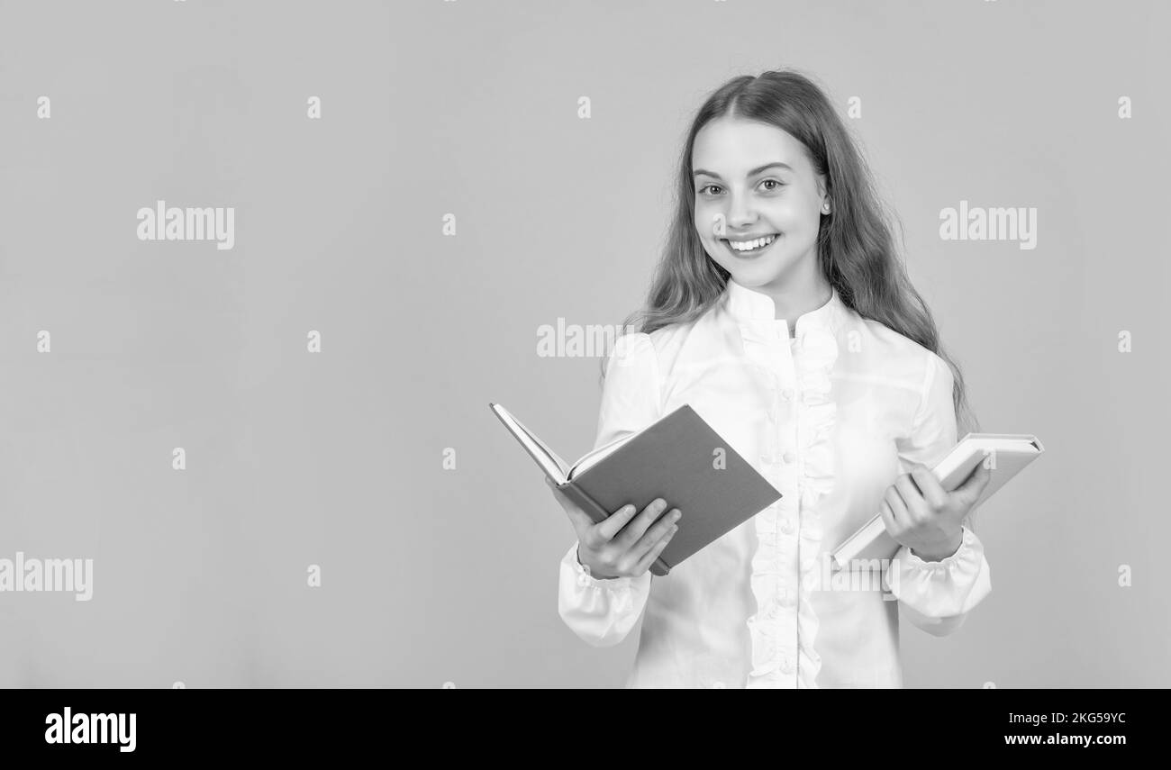 happy child ready to study do homework read book on yellow background ...