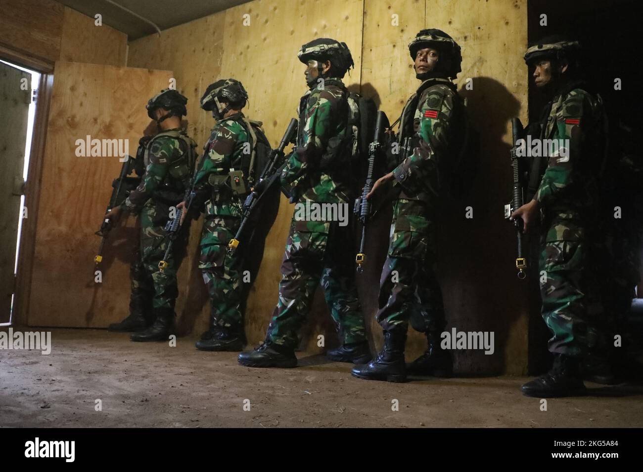 Soldiers from the Indonesian Army prepare to exit a building during a ...