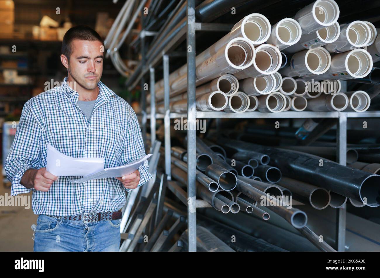 Engineer or foreman holding documents and checking inventory or job ...