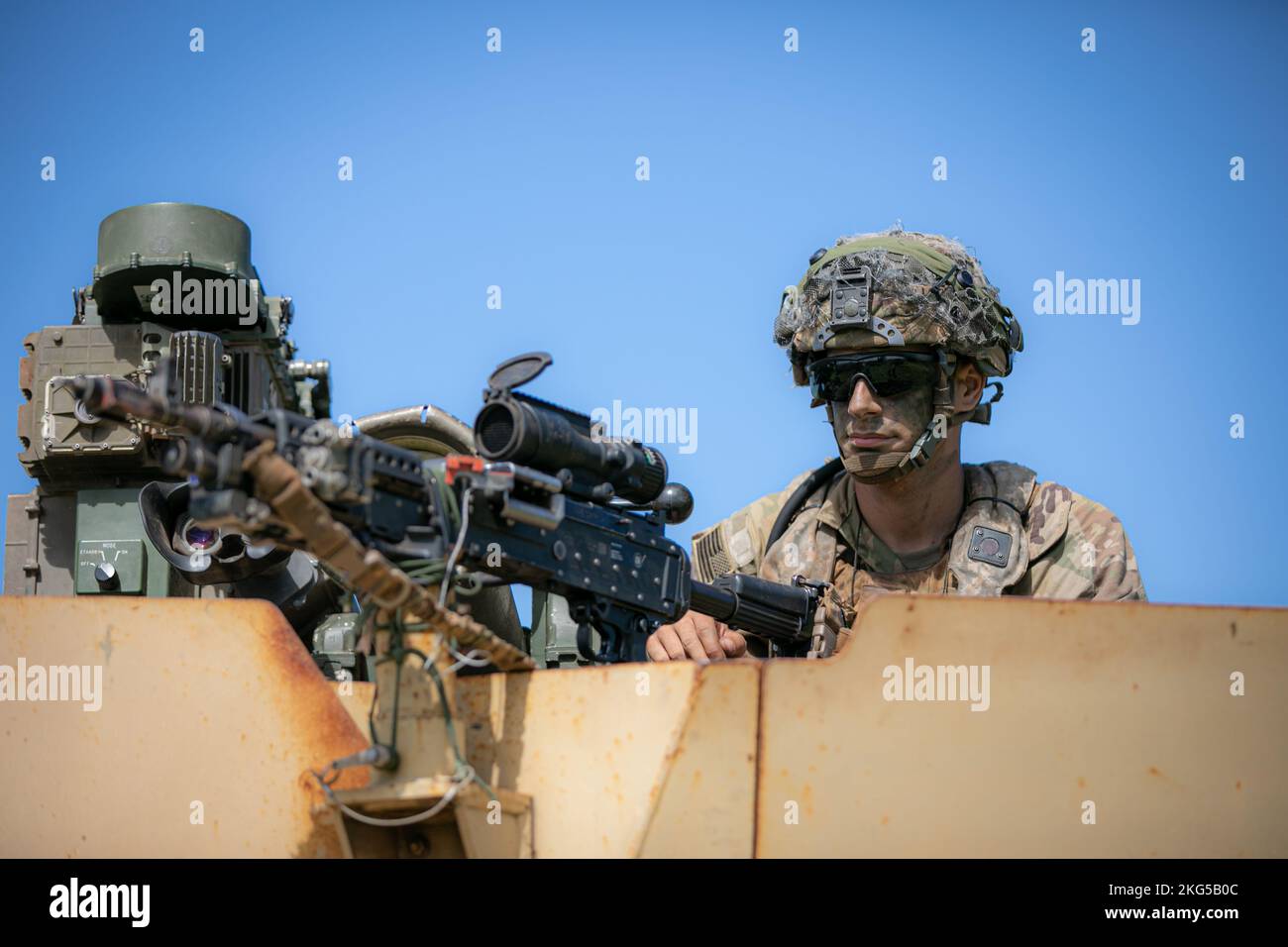 A U.S. Army Soldier with the 25th Infantry Division, sits in a turret ...
