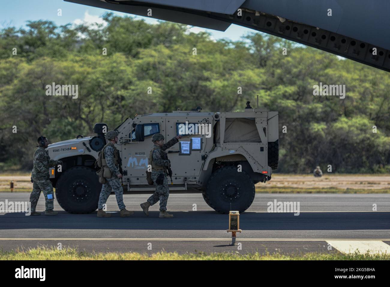 U.S. Air Force Staff Sgt. Jose Molestina, 204th Airlift Squadron loadmaster, and U.S. Marines ...