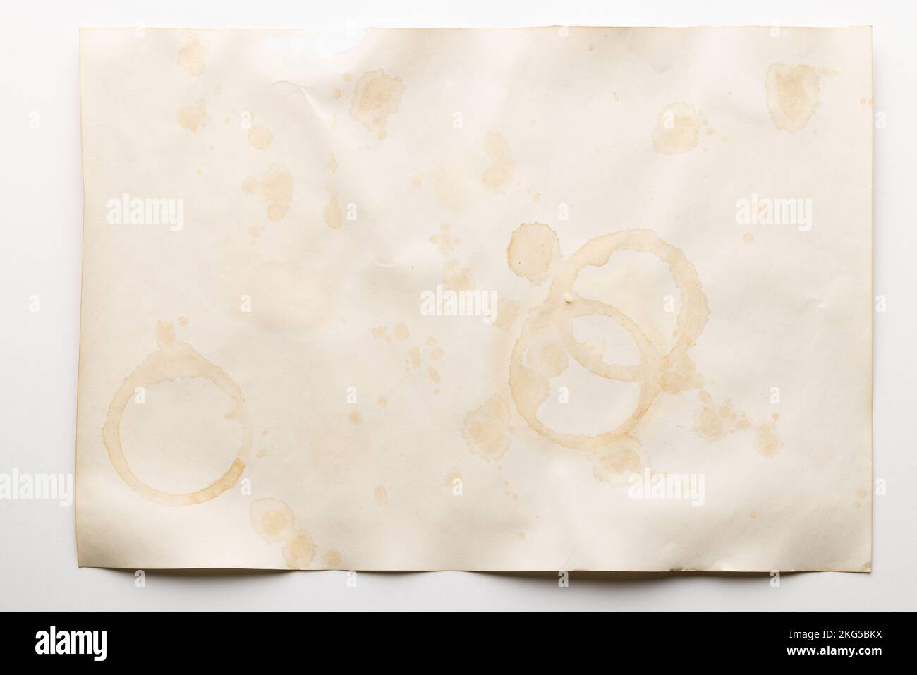 White stained piece of paper with copy space on white background Stock ...