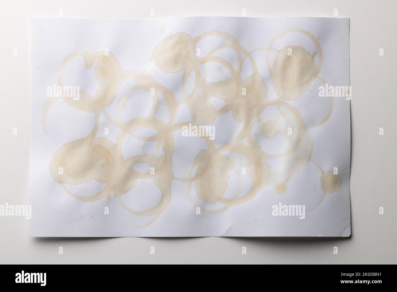 White stained piece of paper with copy space on white background Stock ...