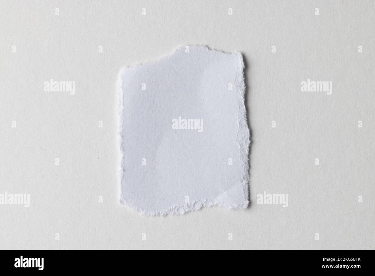 Ripped up piece of white paper with copy space on white background ...
