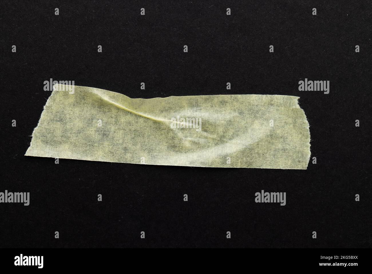 Ripped up piece of masking tape with copy space on black background ...