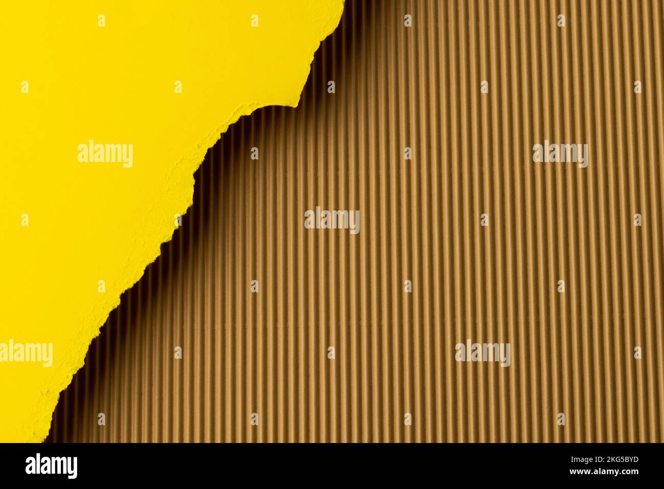 Ripped up pieces of yellow paper with copy space on cardboard ...