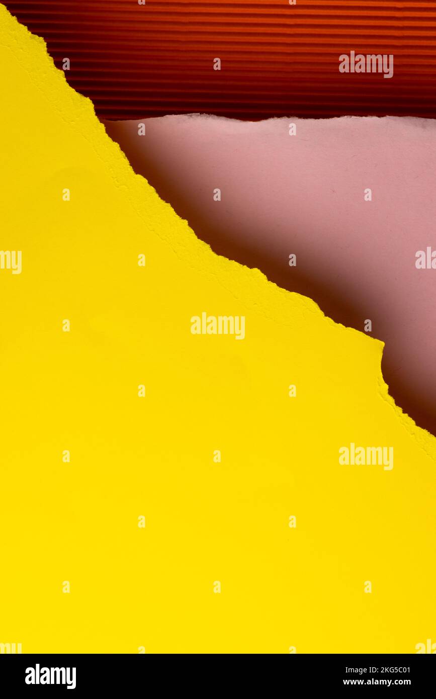 Ripped up pieces of coloured paper with copy space on cardboard ...