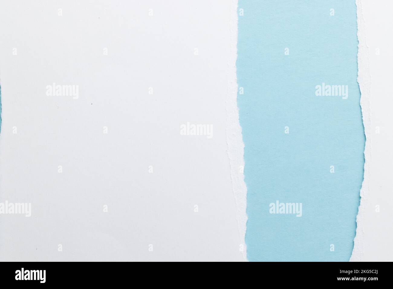 Ripped up pieces of white paper with copy space on blue background ...